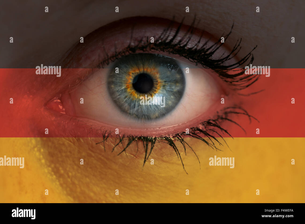 Eye looks through Germany flag background concept macro Stock Photo - Alamy