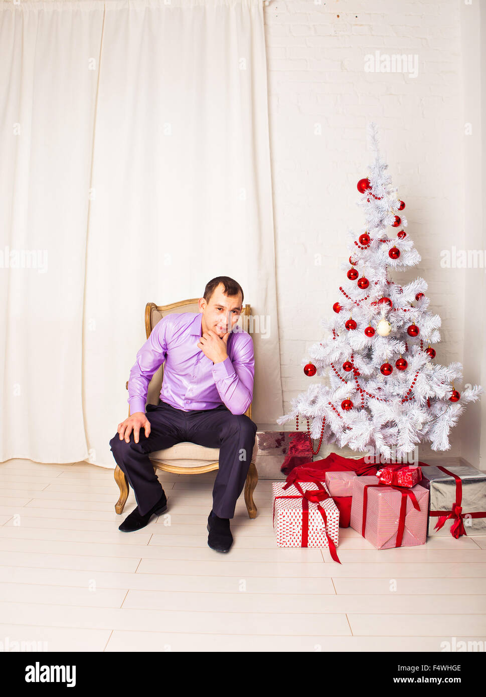 man with Christmas tree at home Stock Photo - Alamy