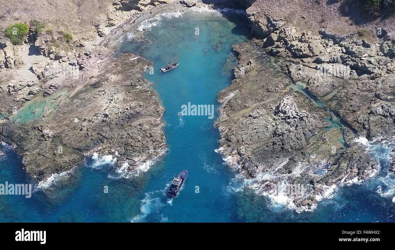 Boats in a small bay along the coast of Desecheo Island, Puerto Rico ...