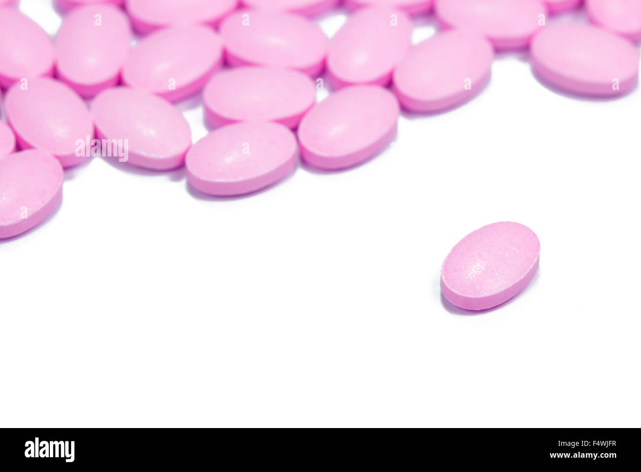The pink tablets isolated on white background Stock Photo - Alamy