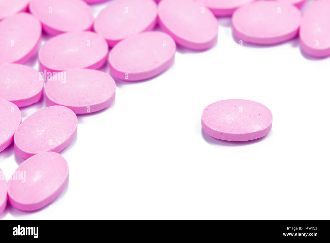 The pink tablets isolated on white background Stock Photo - Alamy
