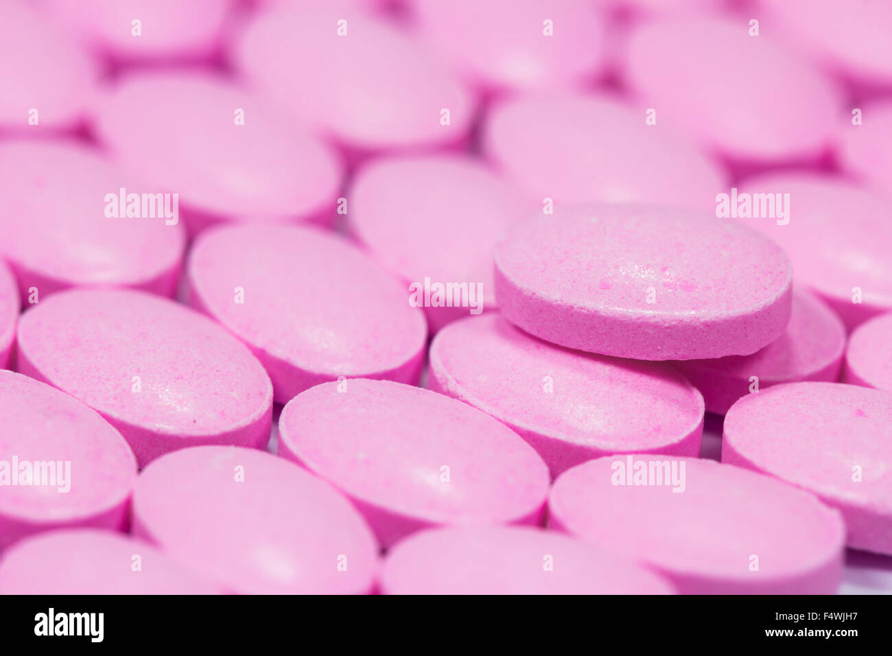 The pink tablets isolated on white background Stock Photo - Alamy