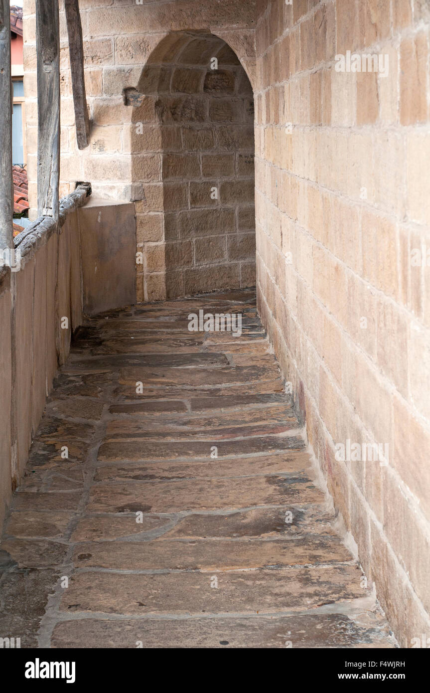 Narrow passage cobblestoned with archs outside the church of St ...