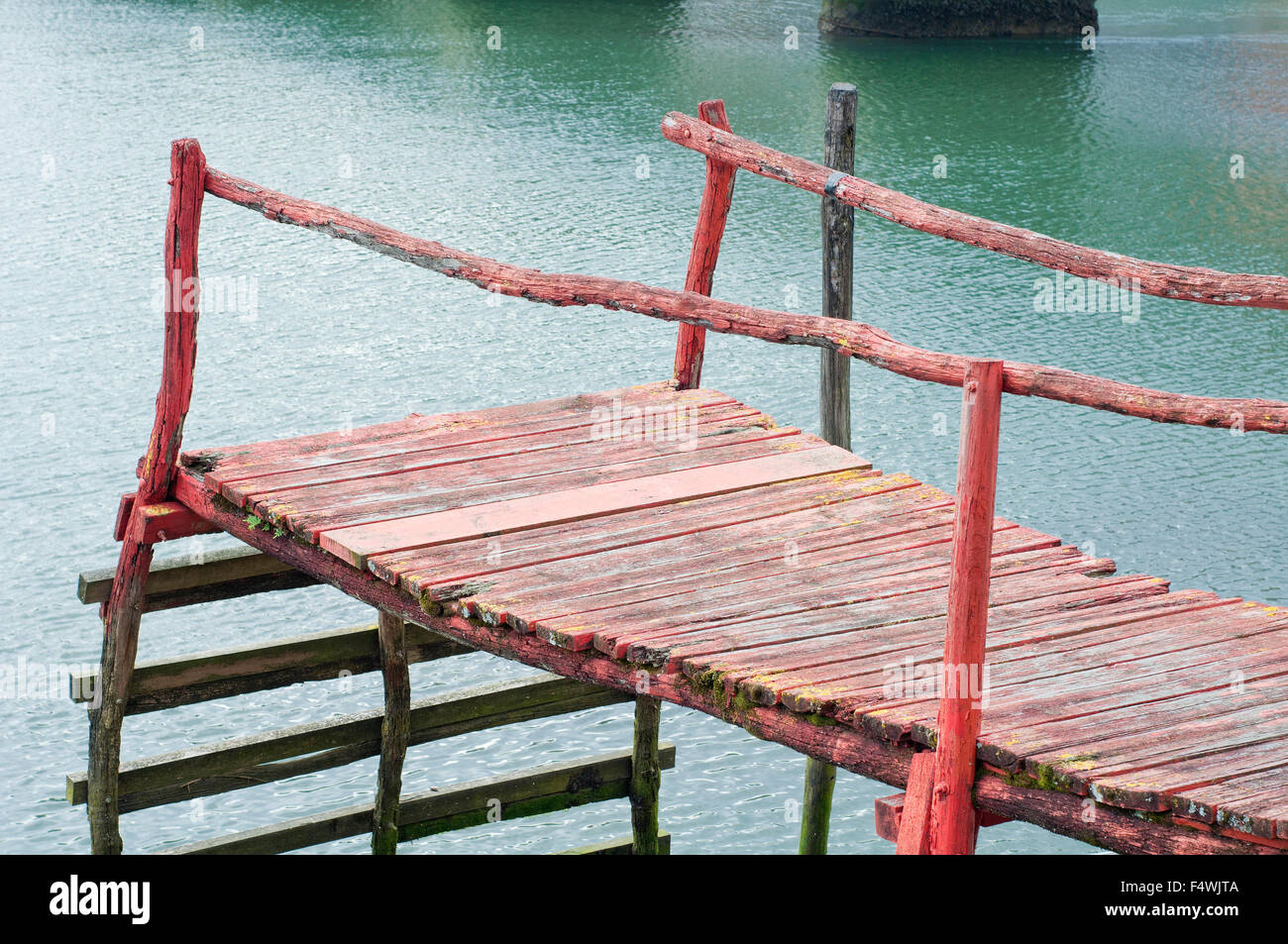 Old wooden boat dock red painted on the sea. Basque Country. Spain ...
