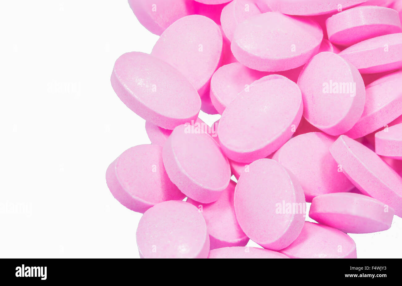 The pink tablets isolated on white background Stock Photo - Alamy