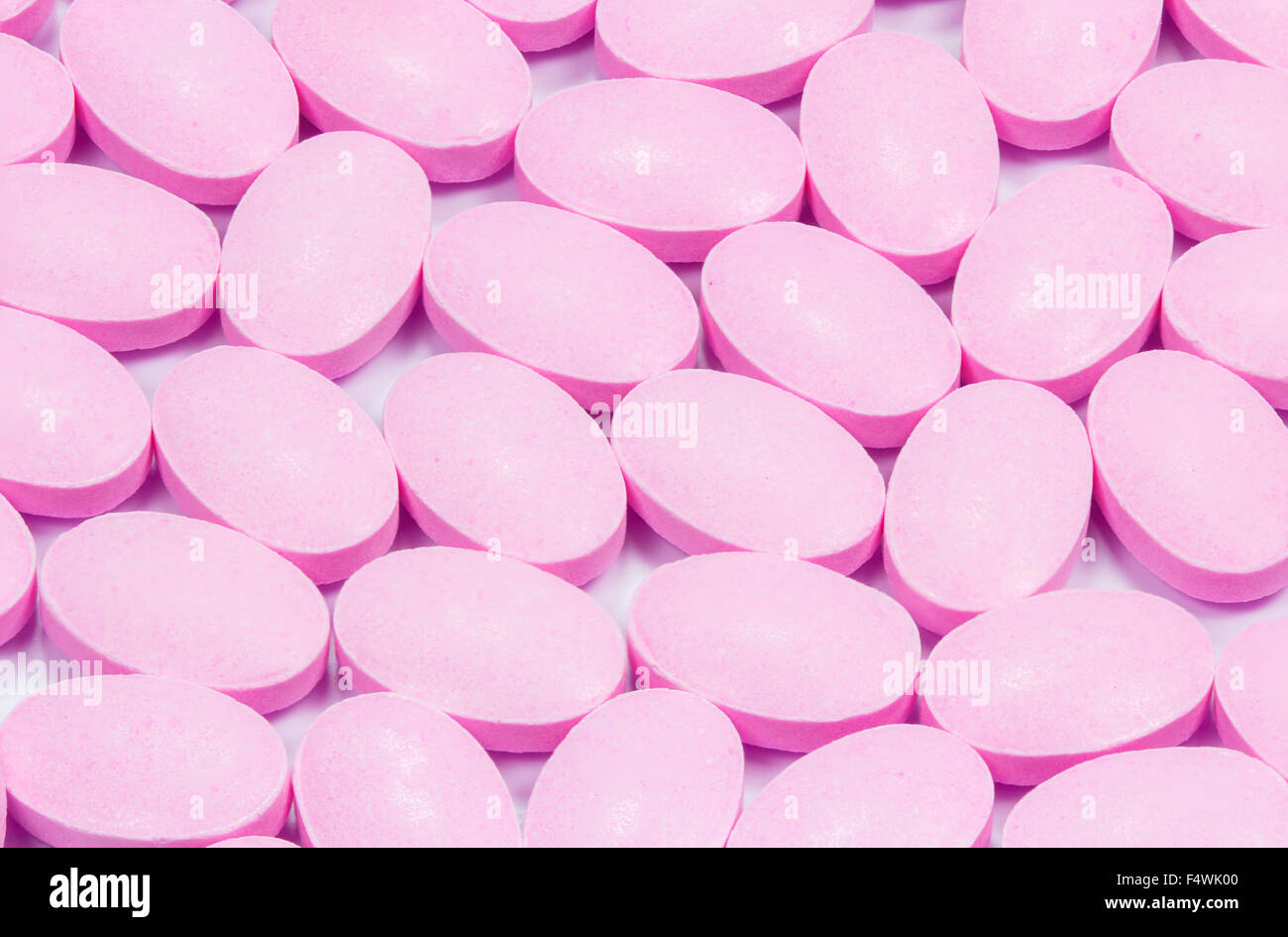 The pink tablets isolated on white background Stock Photo - Alamy