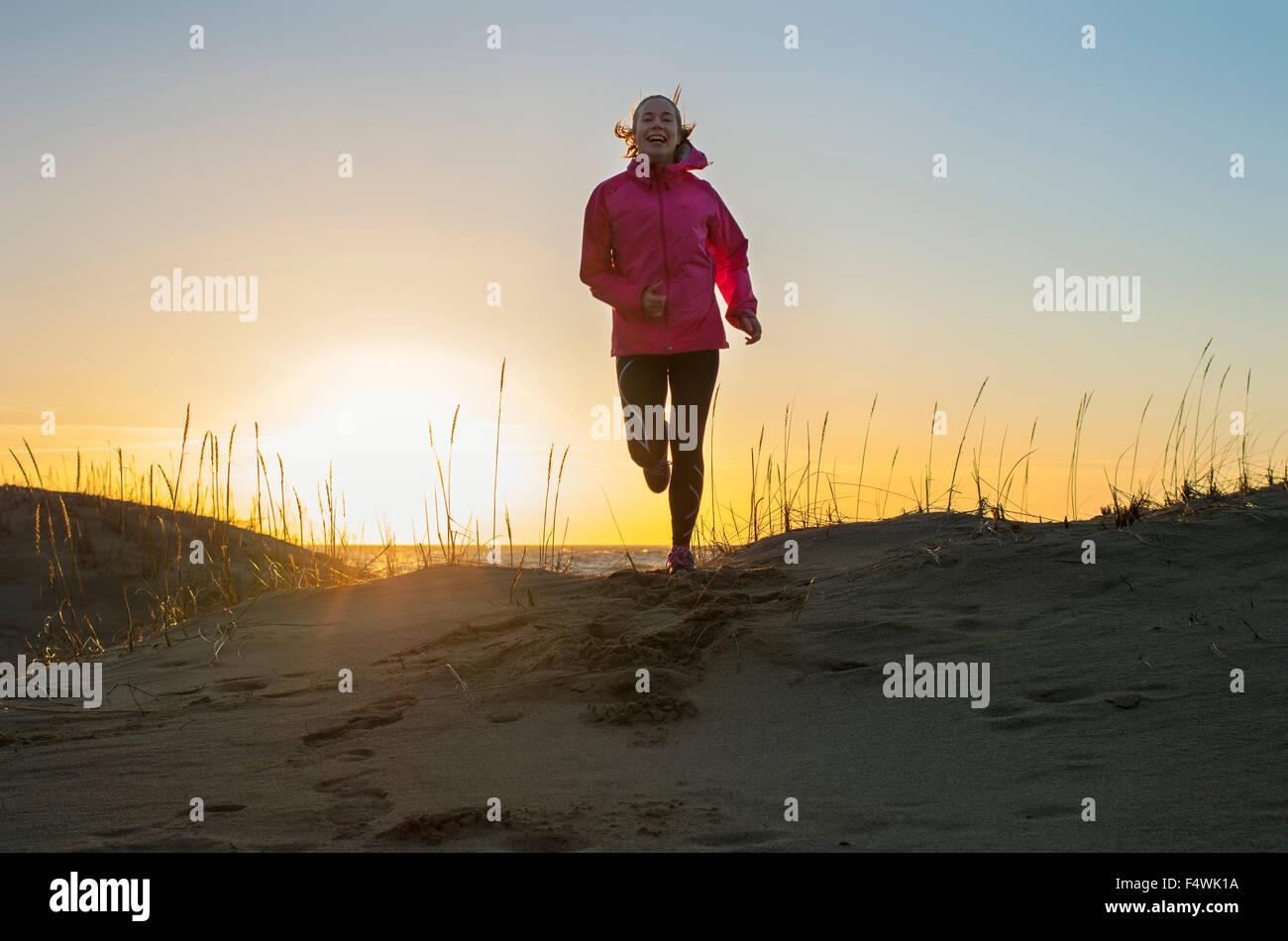 Person jogging on beach hi-res stock photography and images - Alamy