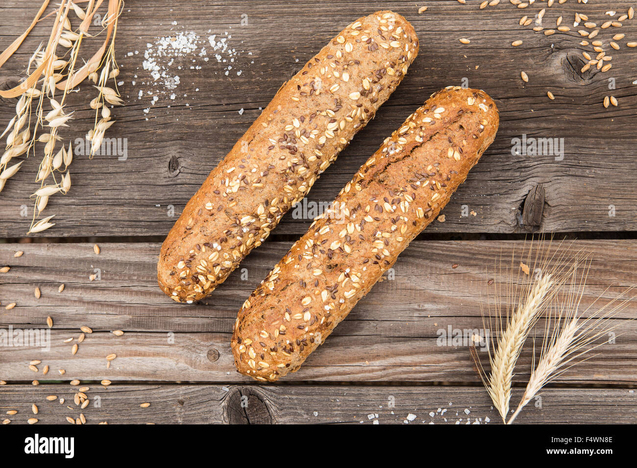 Rustic baguette and wheat on an old vintage planked wood table Stock ...