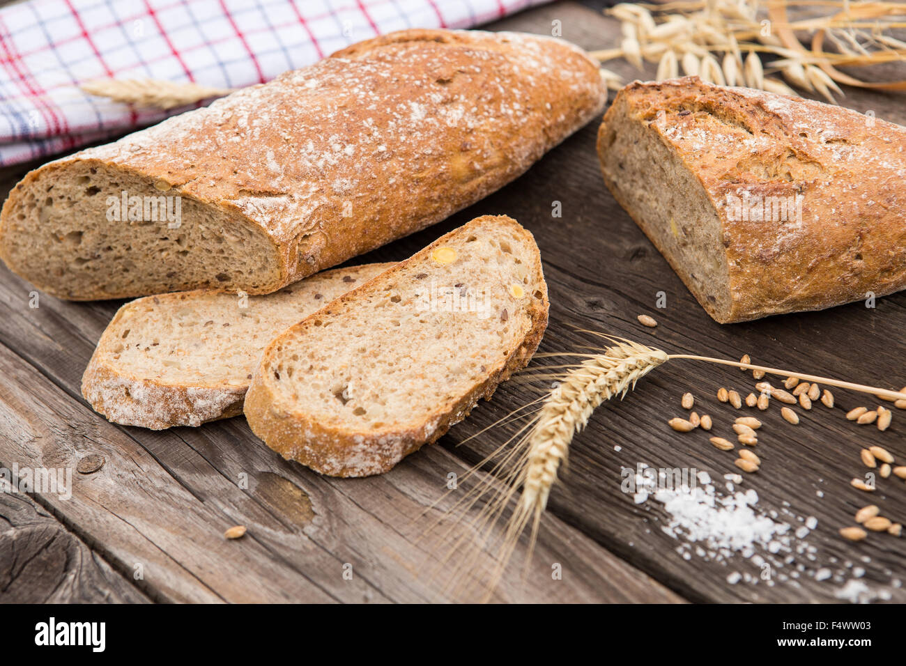 Rustic bread and wheat on an old vintage planked wood table Stock Photo ...
