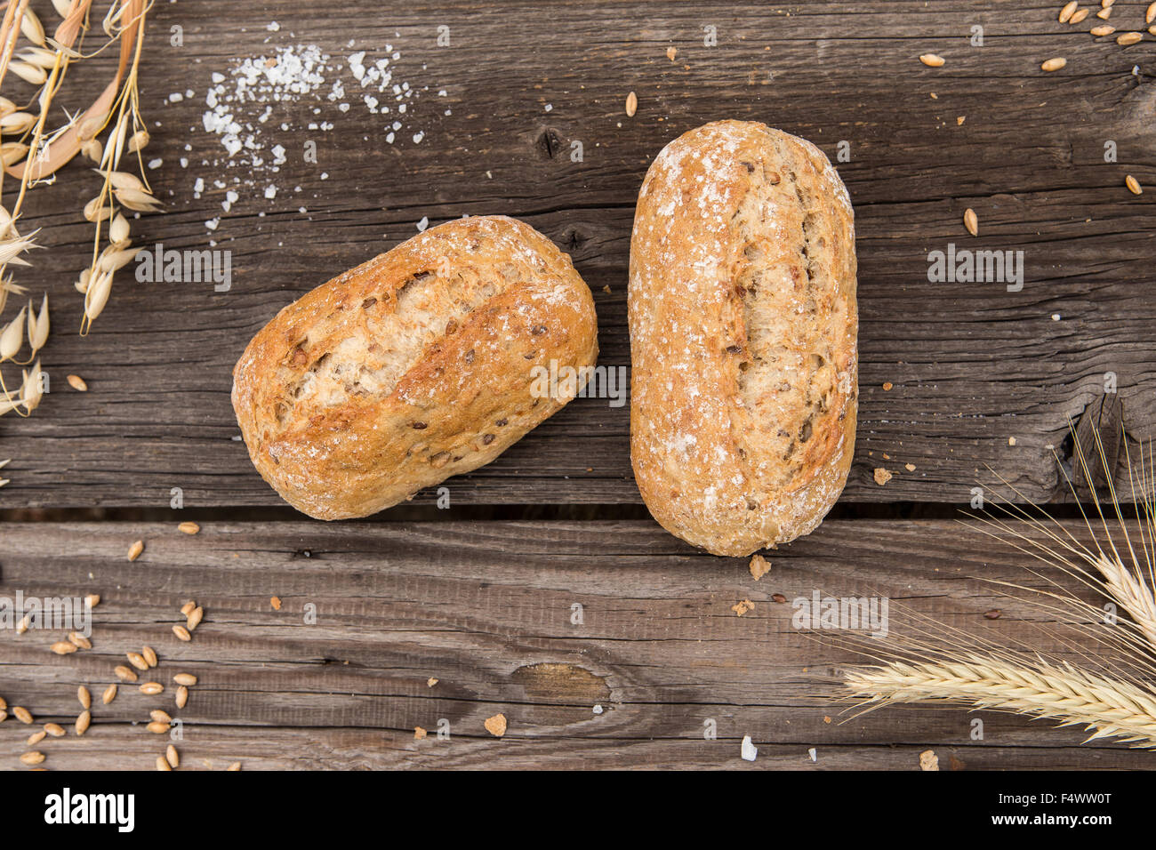 Rustic baguette and wheat on an old vintage planked wood table Stock ...