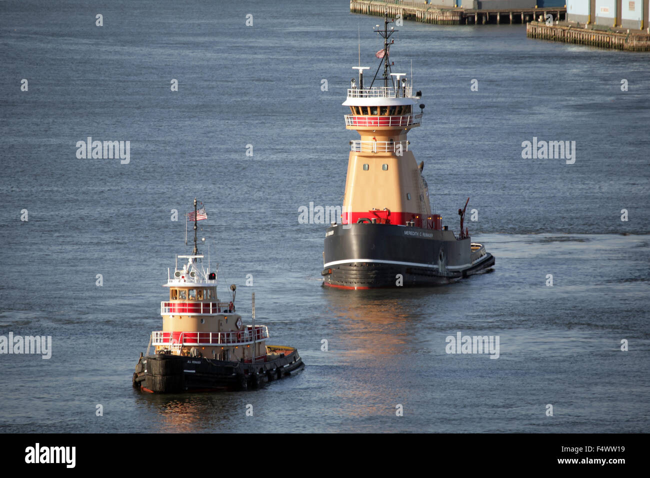 Two Reinauer tugboats sailing in the East River in New York City, USA ...