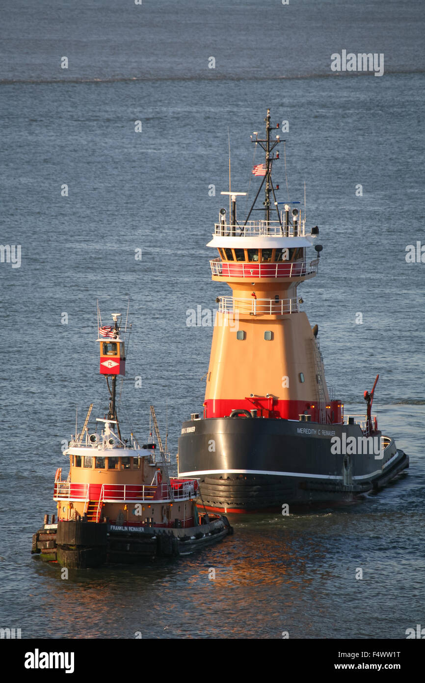 Two Meredith C. Reinauer tugboats sailing in the East River in New York ...