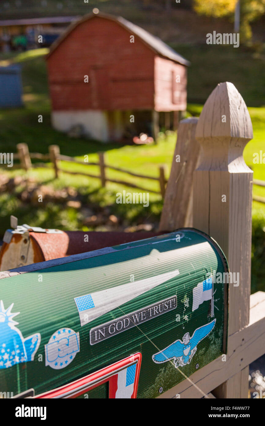 A mail box with In God We Trust by an old wooden barn along the Quilt ...