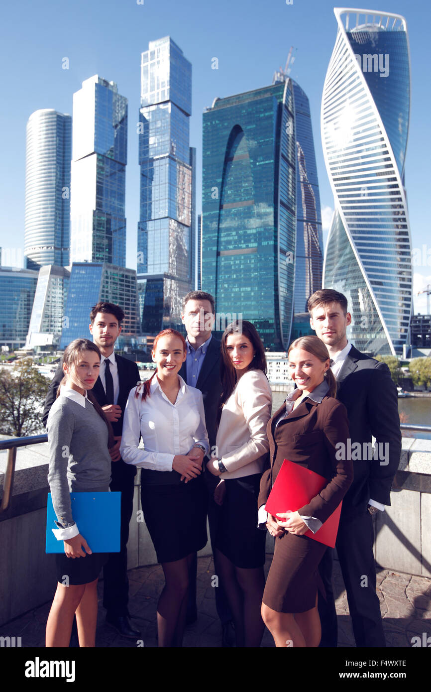 Portrait of business team outside office on skyscrapers background ...