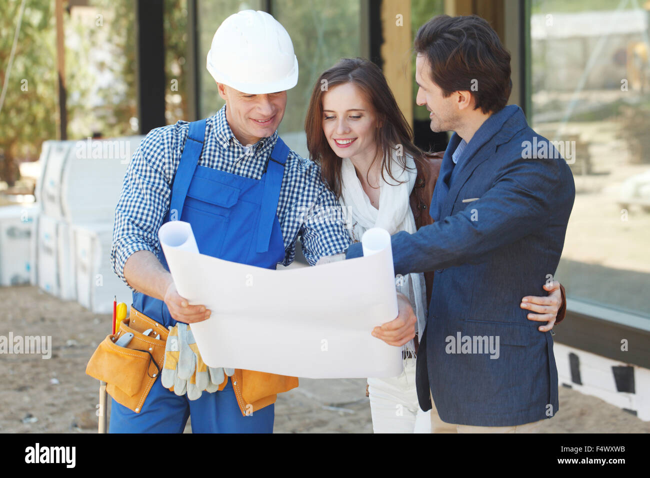 Worker shows construction plan Stock Photo - Alamy
