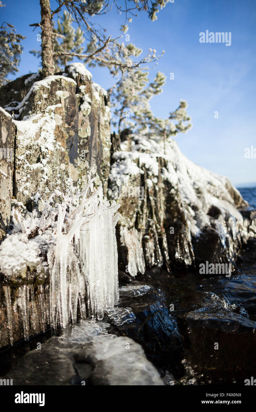 Frozen lakefront rock cliff Stock Photo - Alamy