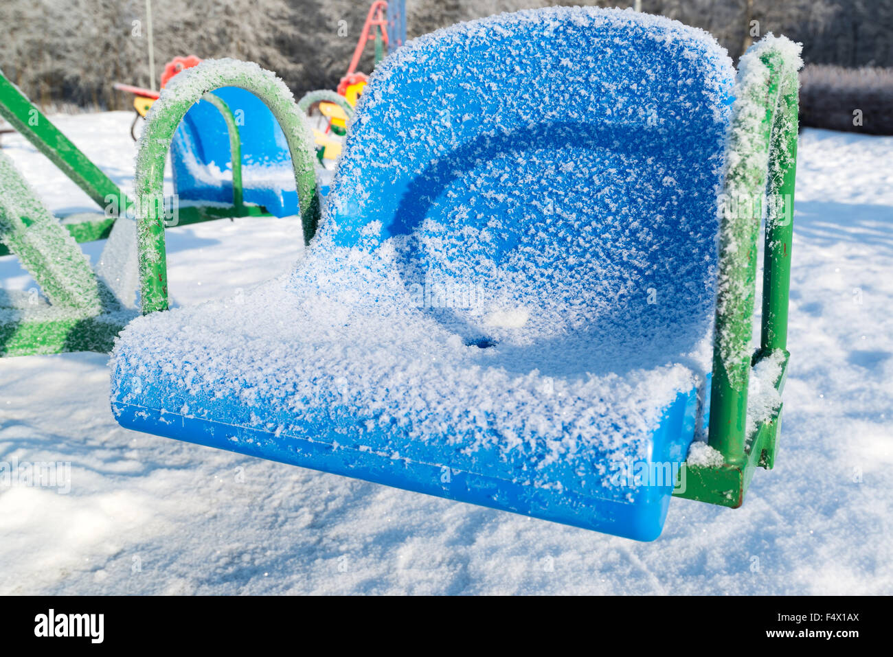 snow covered swing and slide at playground in winter Stock Photo - Alamy