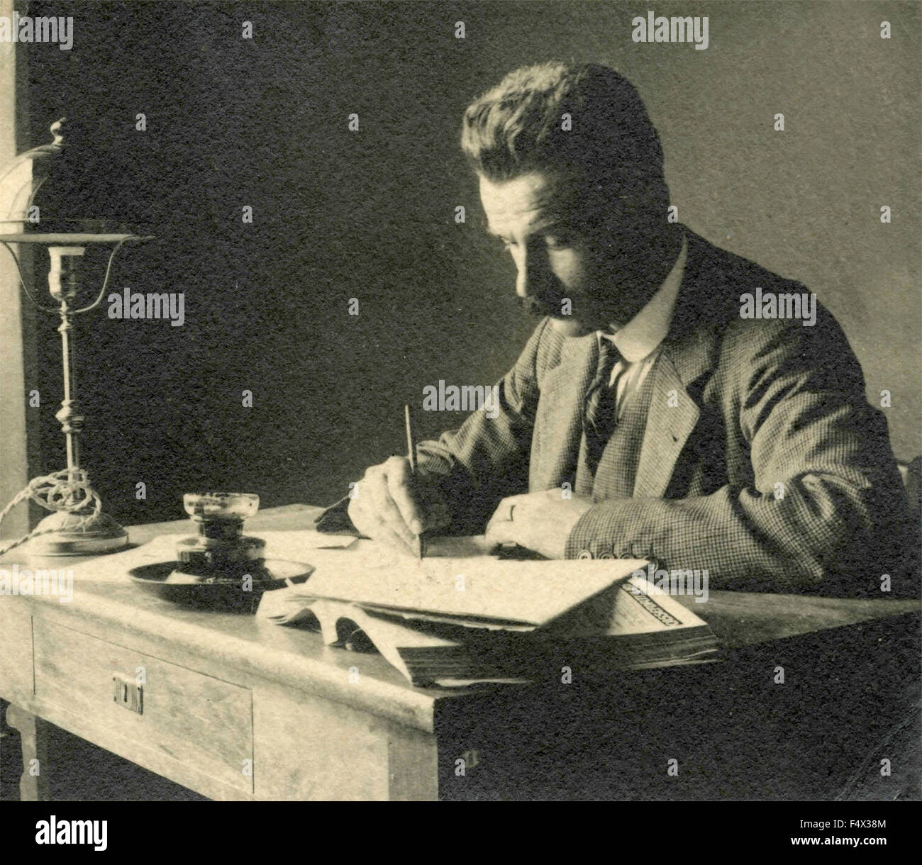 A man sitting at his desk writing papers, Italy Stock Photo - Alamy