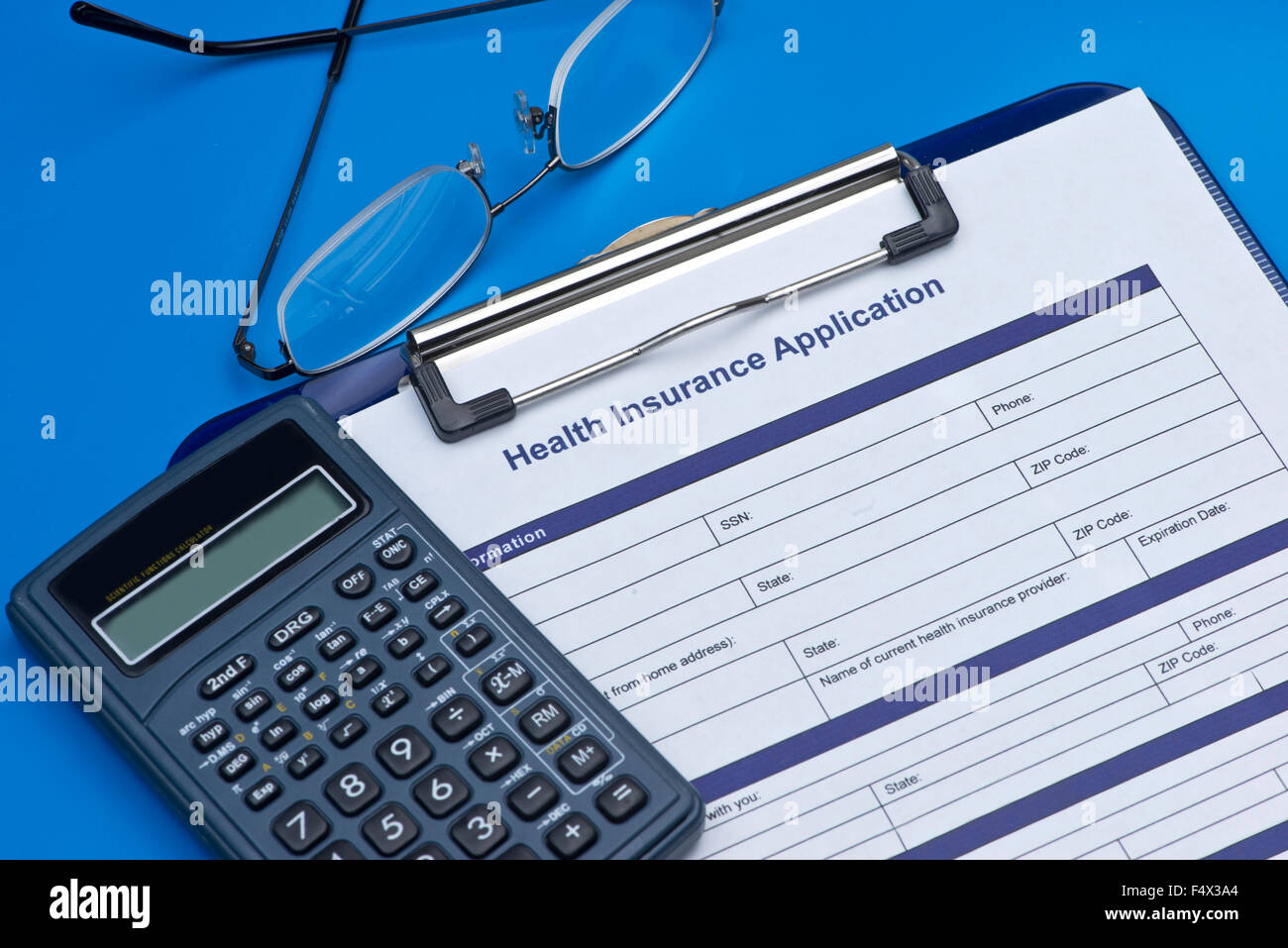 Health insurance application with glasses, and calculator Stock Photo ...