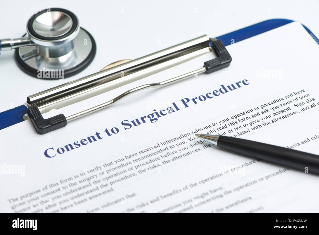 Informed consent for surgical procedure form on white table with ...