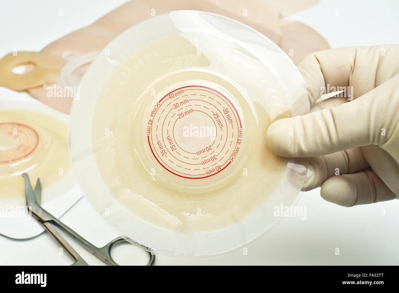 Ostomy wafer held by nurse with ostomy supplies Stock Photo - Alamy