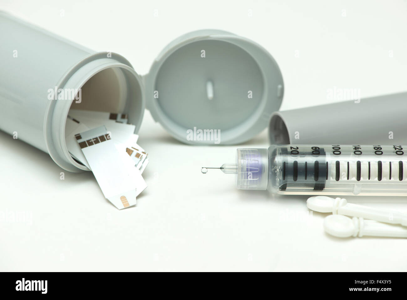 Insulin droplet on insulin pen needle with meter, strip and cannister ...
