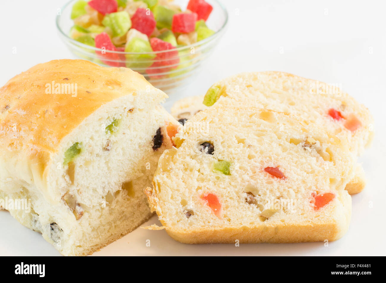 Homebaked colorful fruit bread and a bowl of various dry fruits white ...