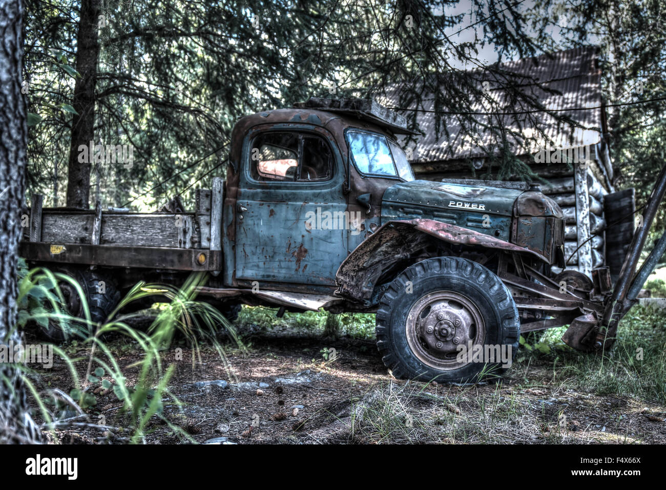 A rusting, old truck sits in the middle of a forest near Anchorage ...