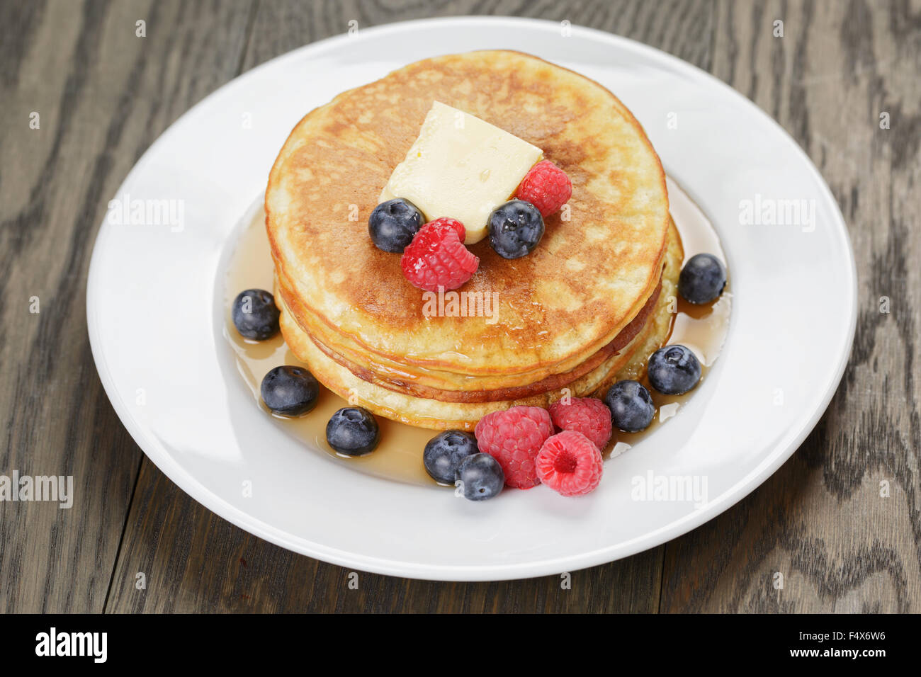 Pancakes with raspberry, blueberry and maple syrup Stock Photo - Alamy