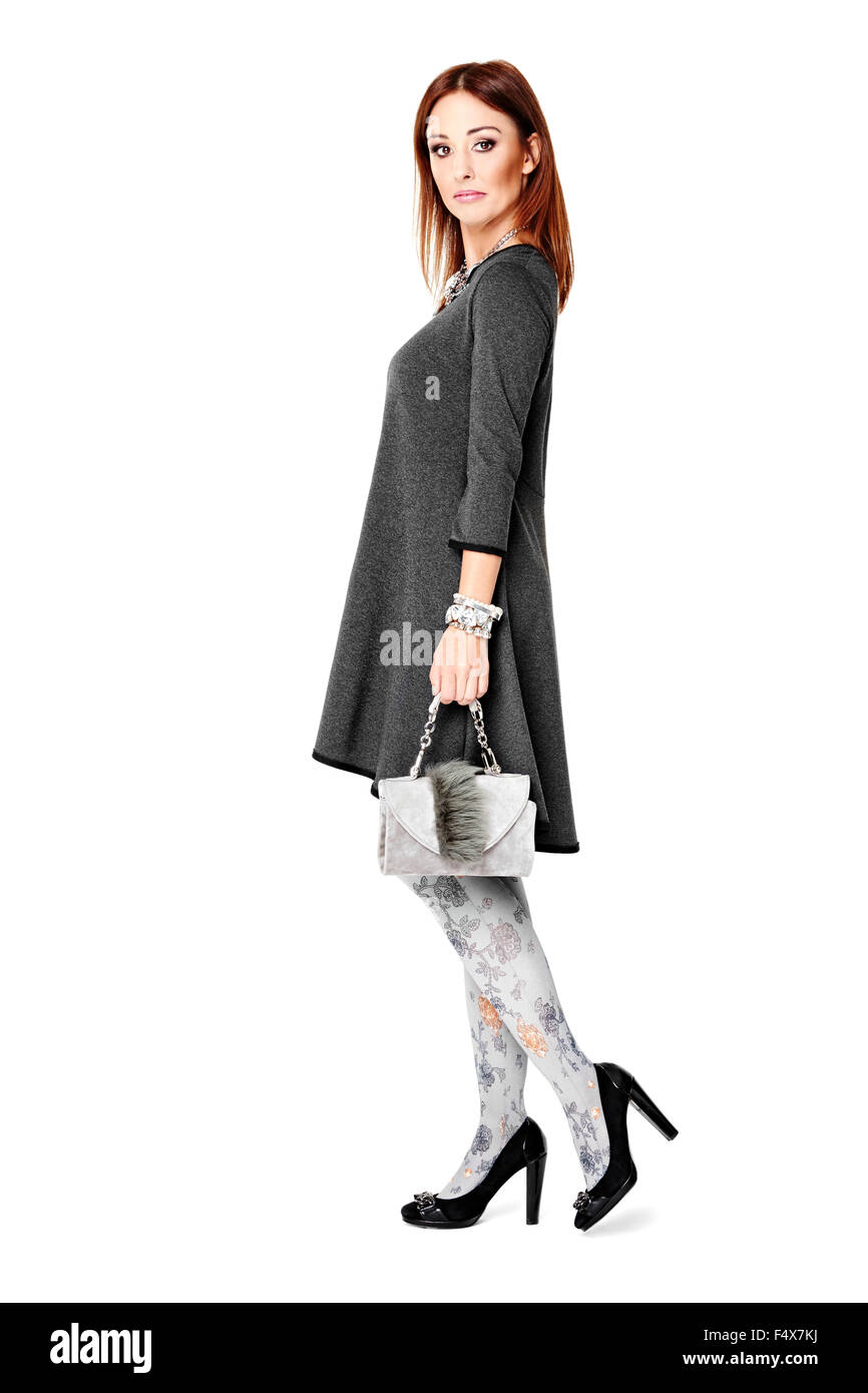 Full length side view of woman carrying handbag. Isolated over white ...