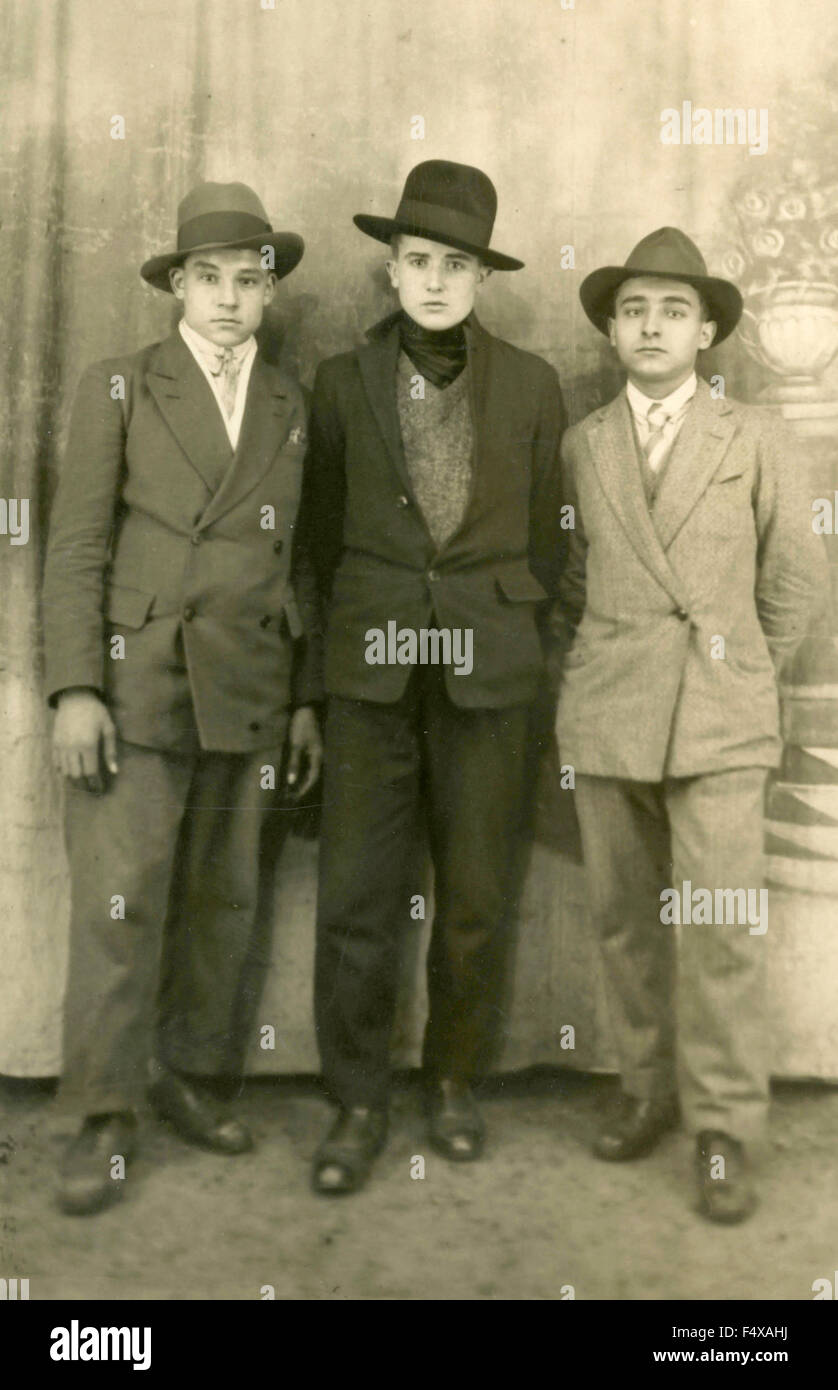 Portrait of three young men with hats, Italy Stock Photo - Alamy