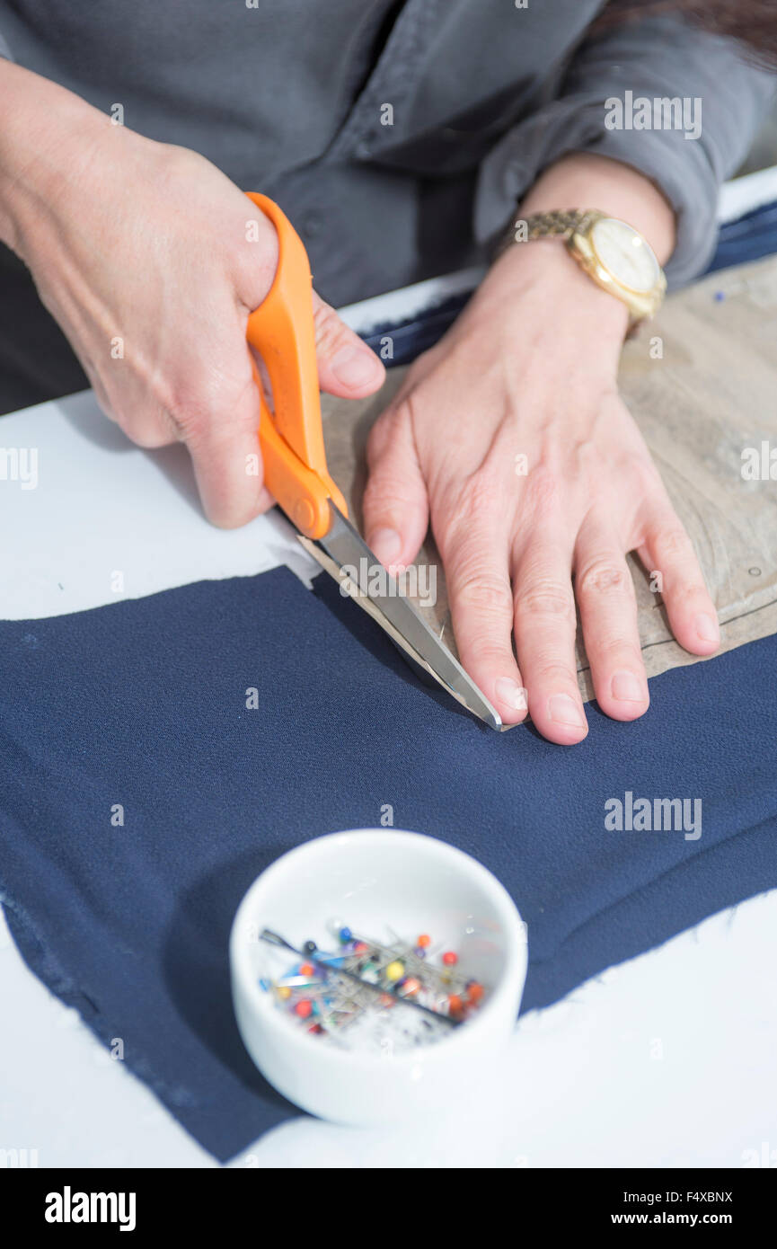 Cutting out cloth pieces from a sewing pattern Stock Photo - Alamy