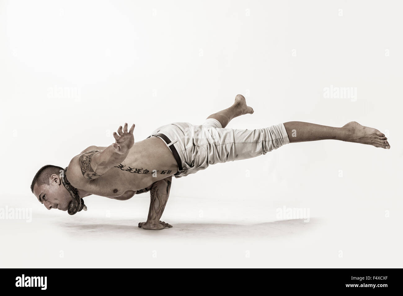 Muscular Shirtless Male Acrobatic Dancer Balancing on Arm and Hand in ...