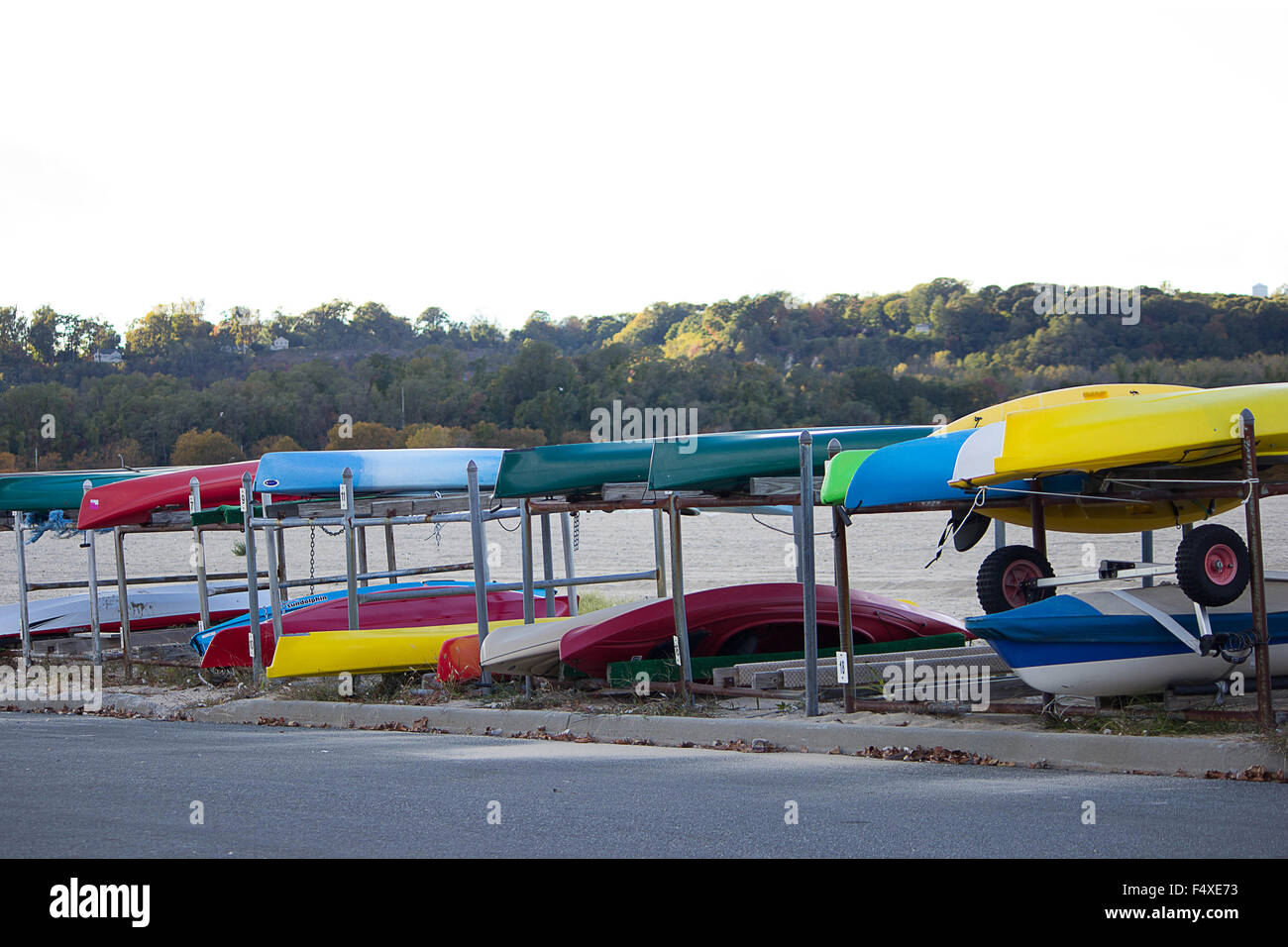 Color Pallette- A colorful array of kayaks and canoes stacked up along ...