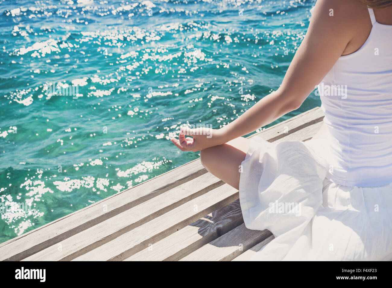 Woman meditating at the sea Stock Photo - Alamy