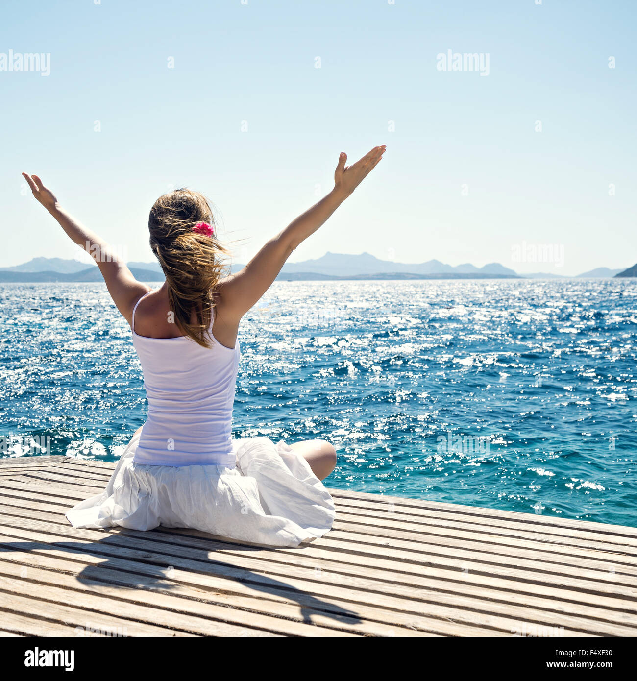 Woman meditating at the sea Stock Photo - Alamy