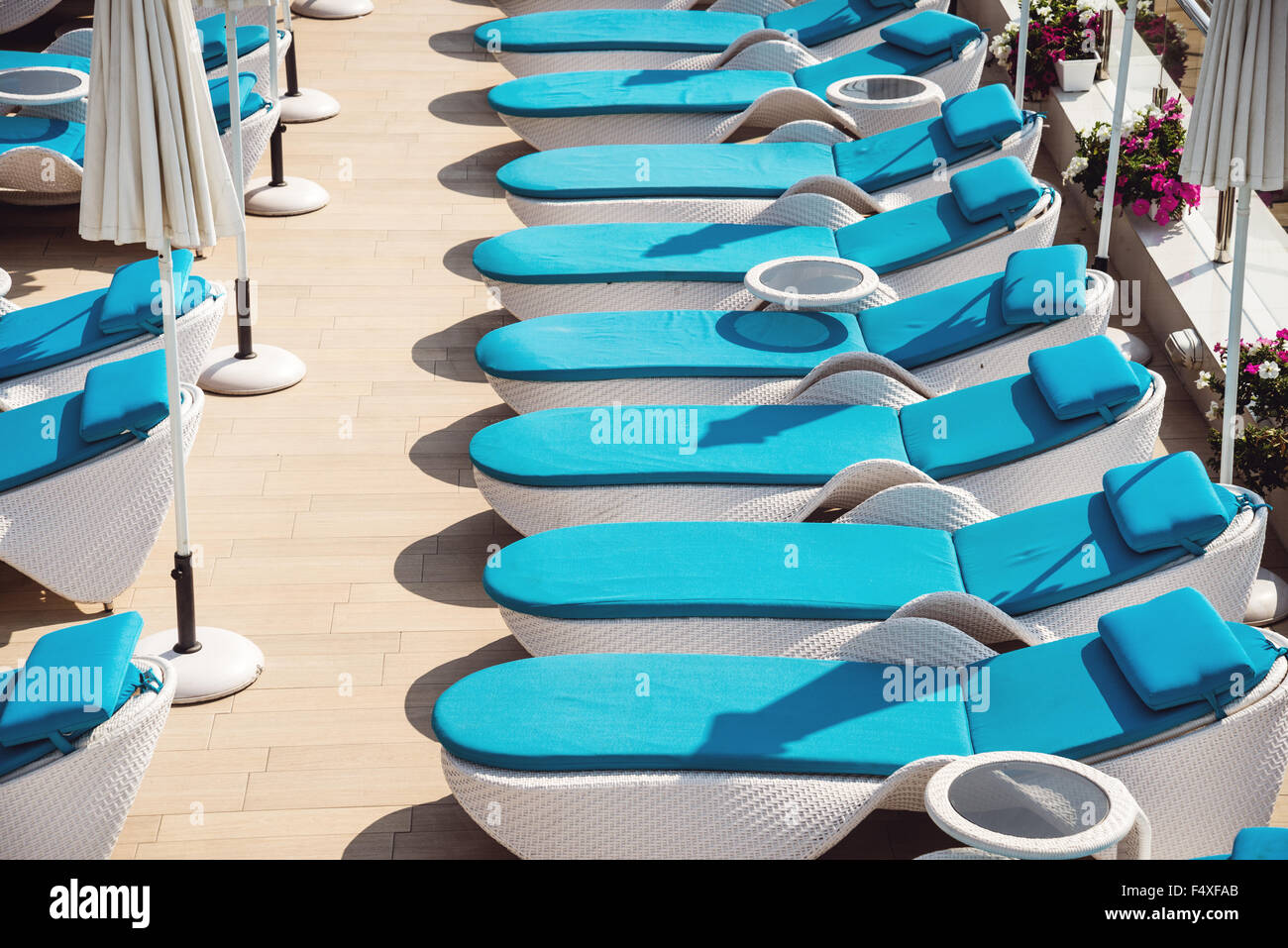 Chaise-longue in swimming pool of luxury hotel Stock Photo - Alamy