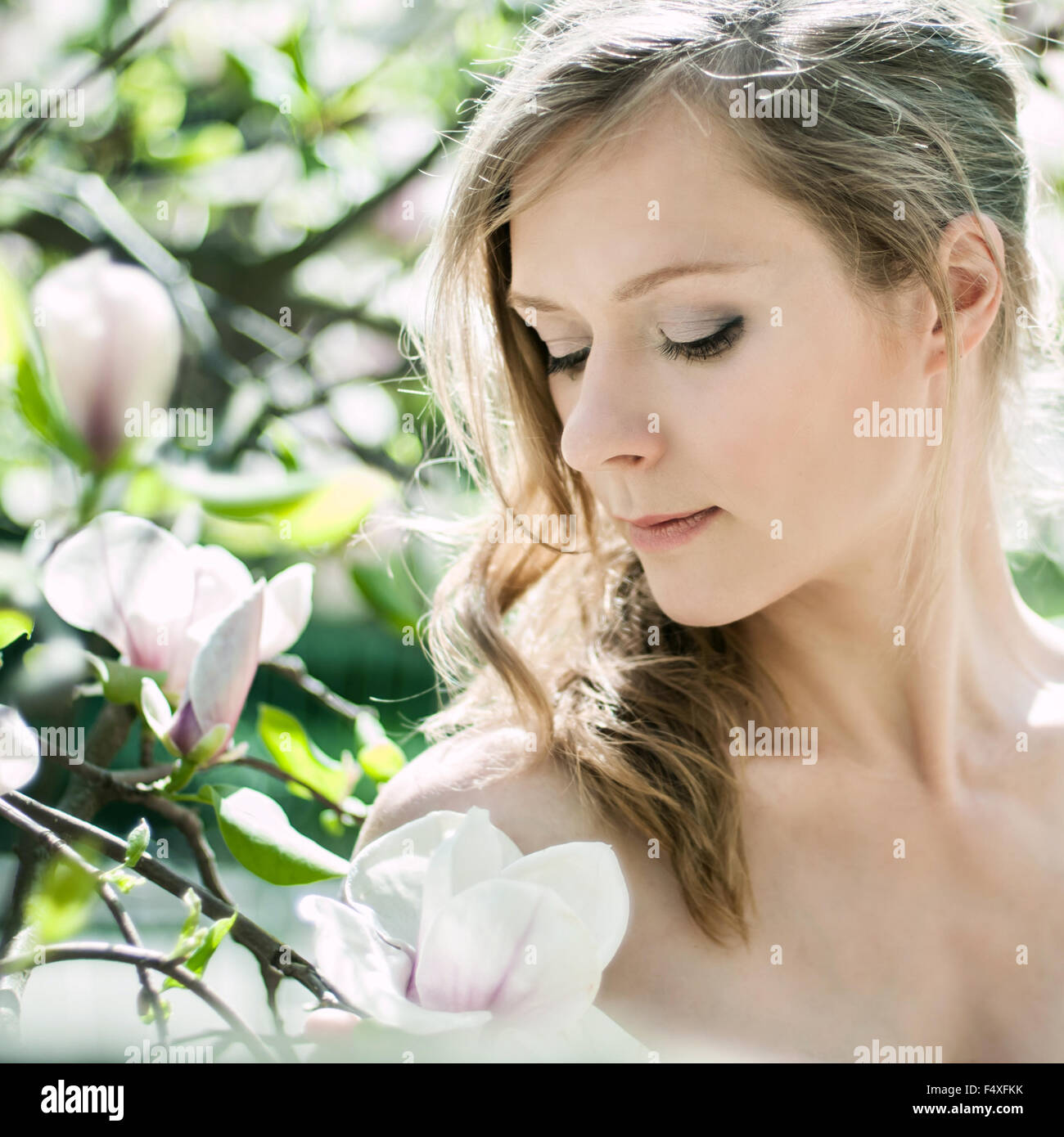Beautiful Spring Girl with the magnolia flowers Stock Photo - Alamy