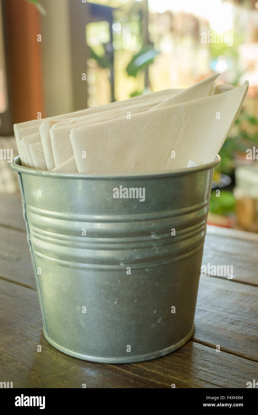 Tissue paper in bucket on wooden table, stock photo Stock Photo - Alamy