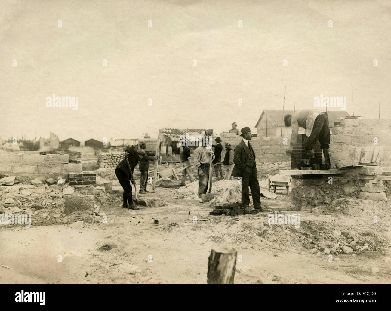 Construction workers on site with a house under construction, Italy ...