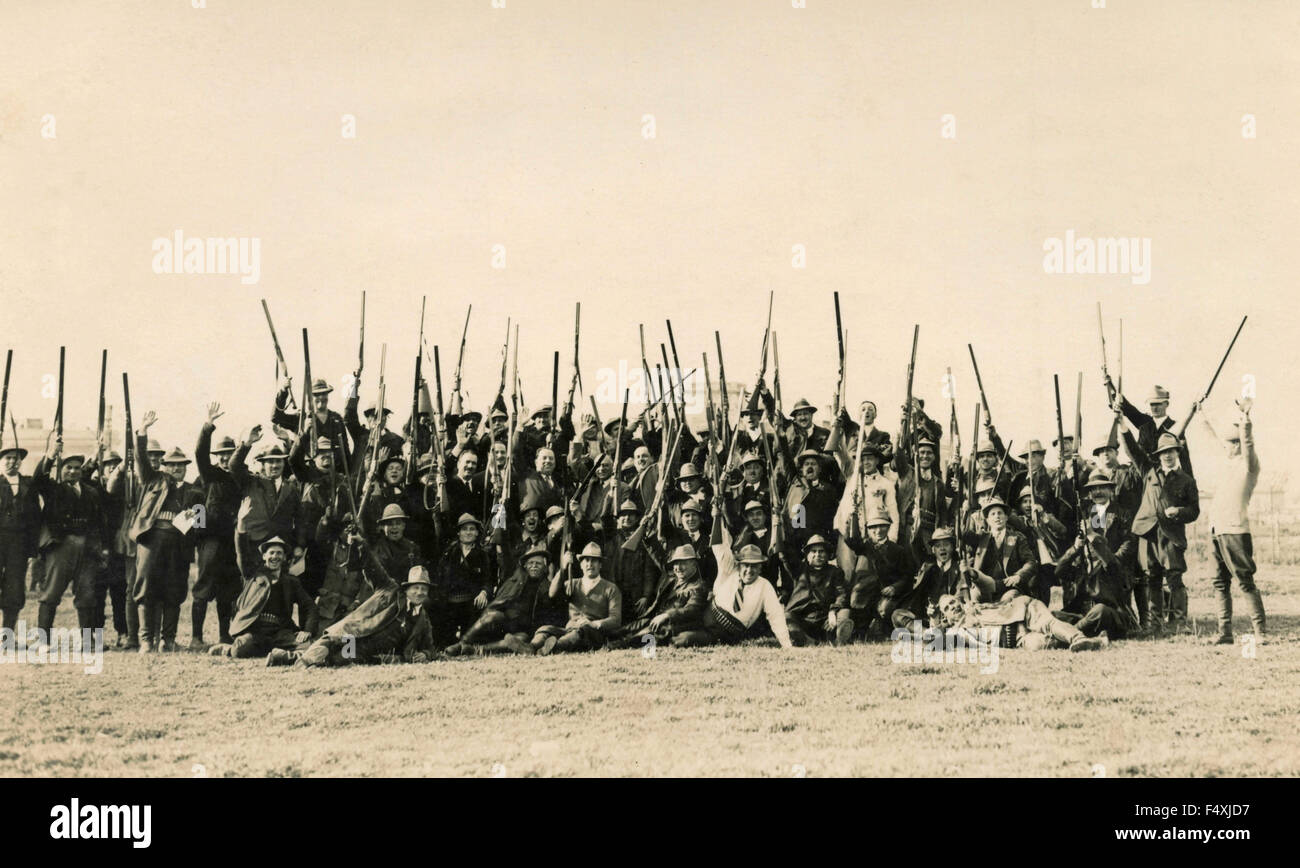 A large group of hunters raising their rifles, Italy Stock Photo - Alamy