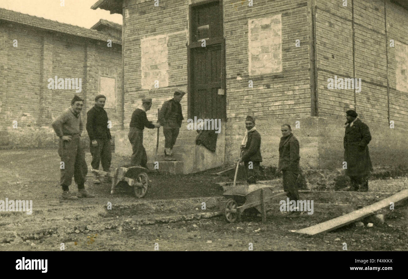 Working group with wheelbarrows in a yard, Italy Stock Photo - Alamy