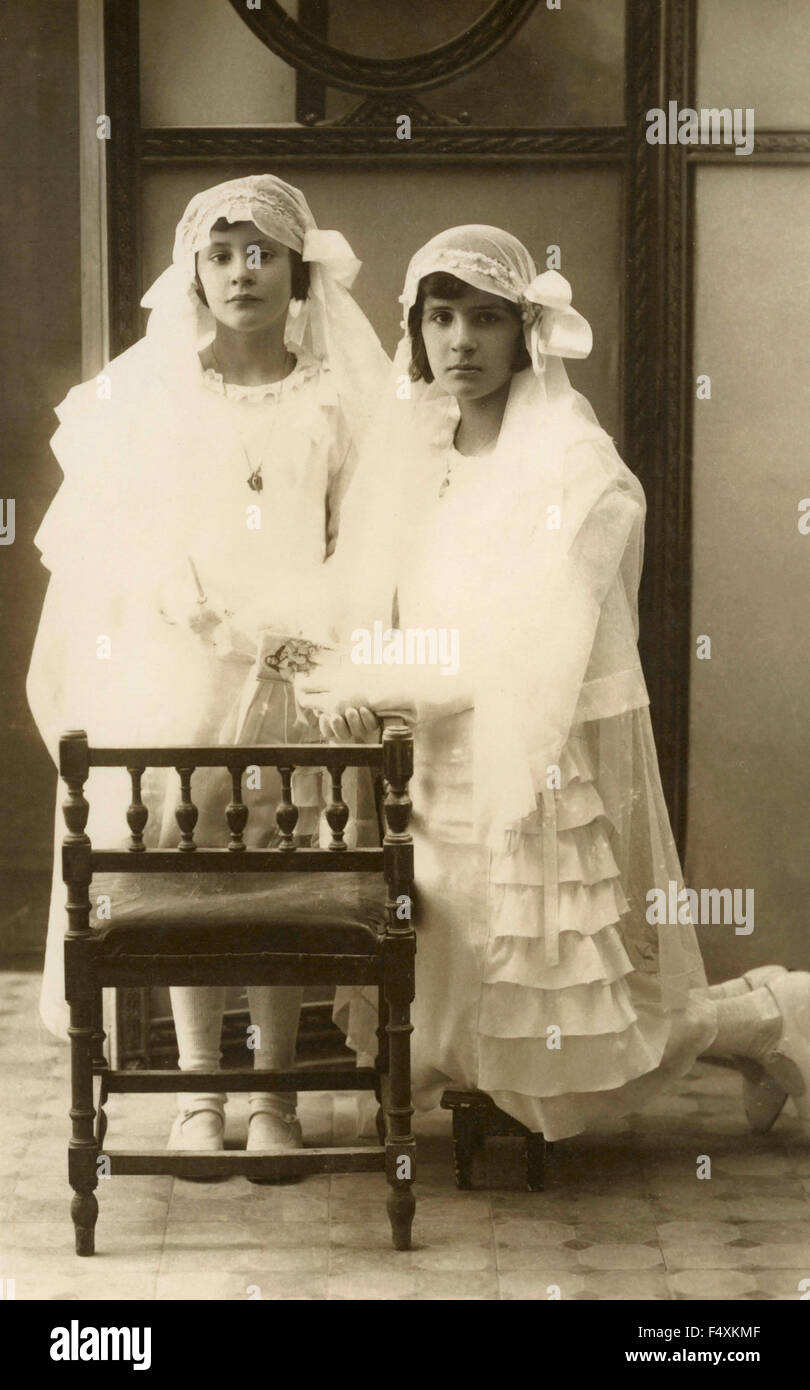 Portrait of two girls wearing white first communion dress, Italy Stock ...