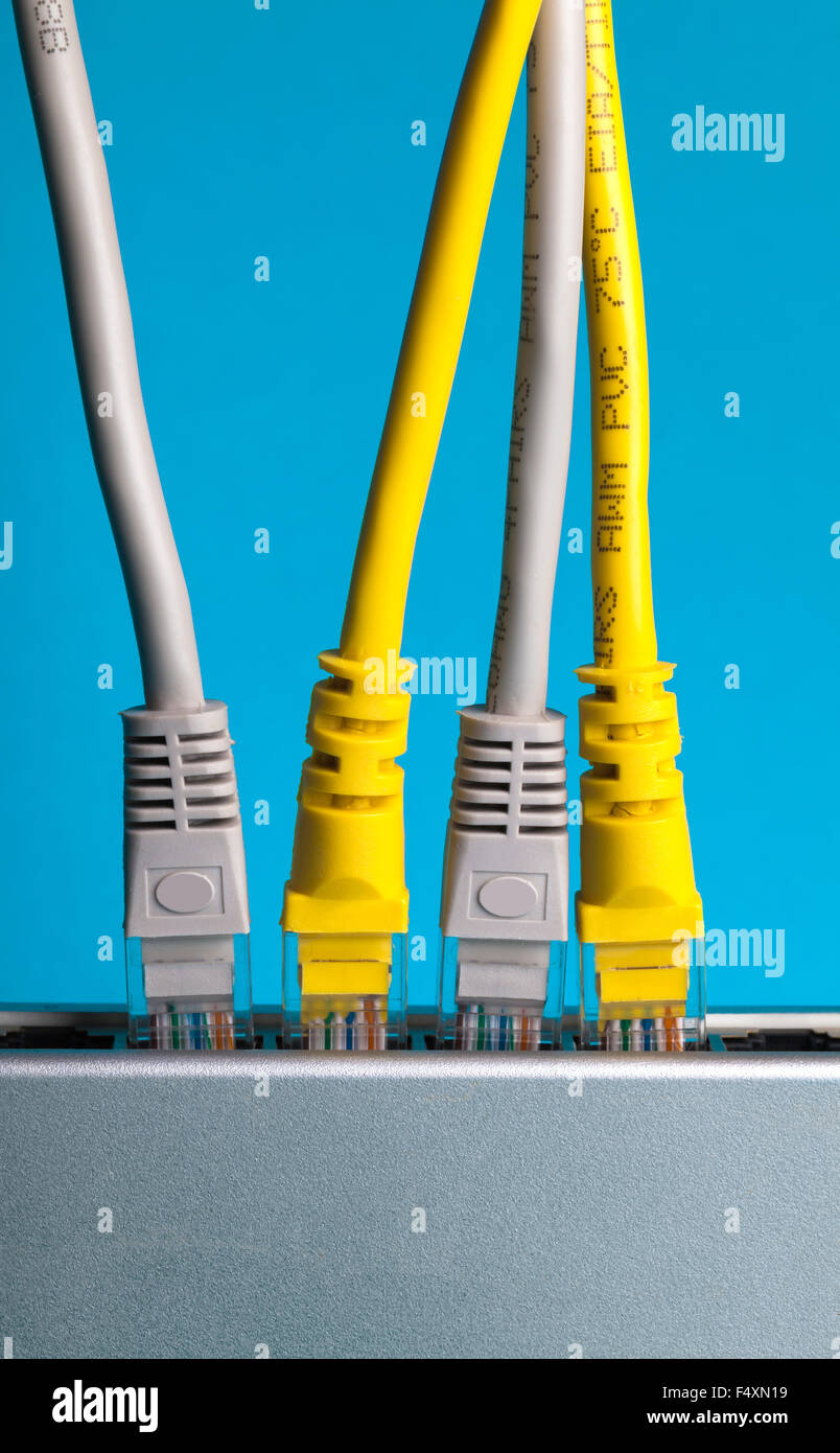 router with wires closeup on a blue background Stock Photo - Alamy