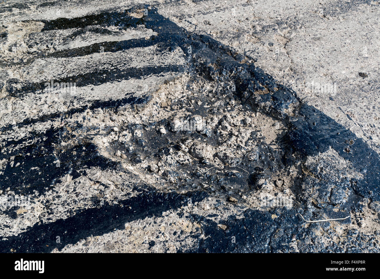 Road repair. Hole in asphalt and bitumen Stock Photo - Alamy