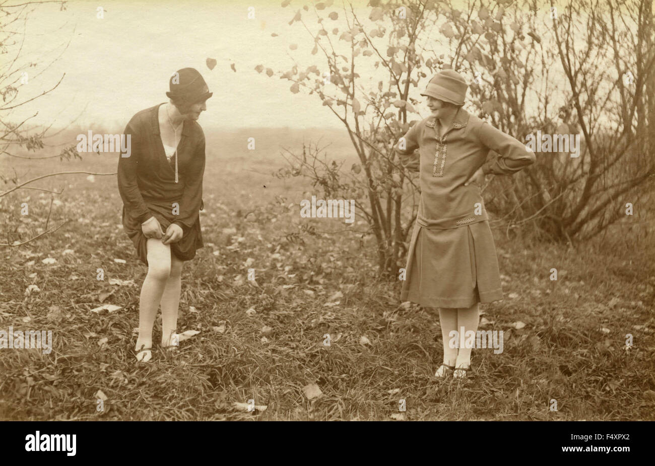 Two women in a meadow, a pull up your socks, Denmark Stock Photo - Alamy