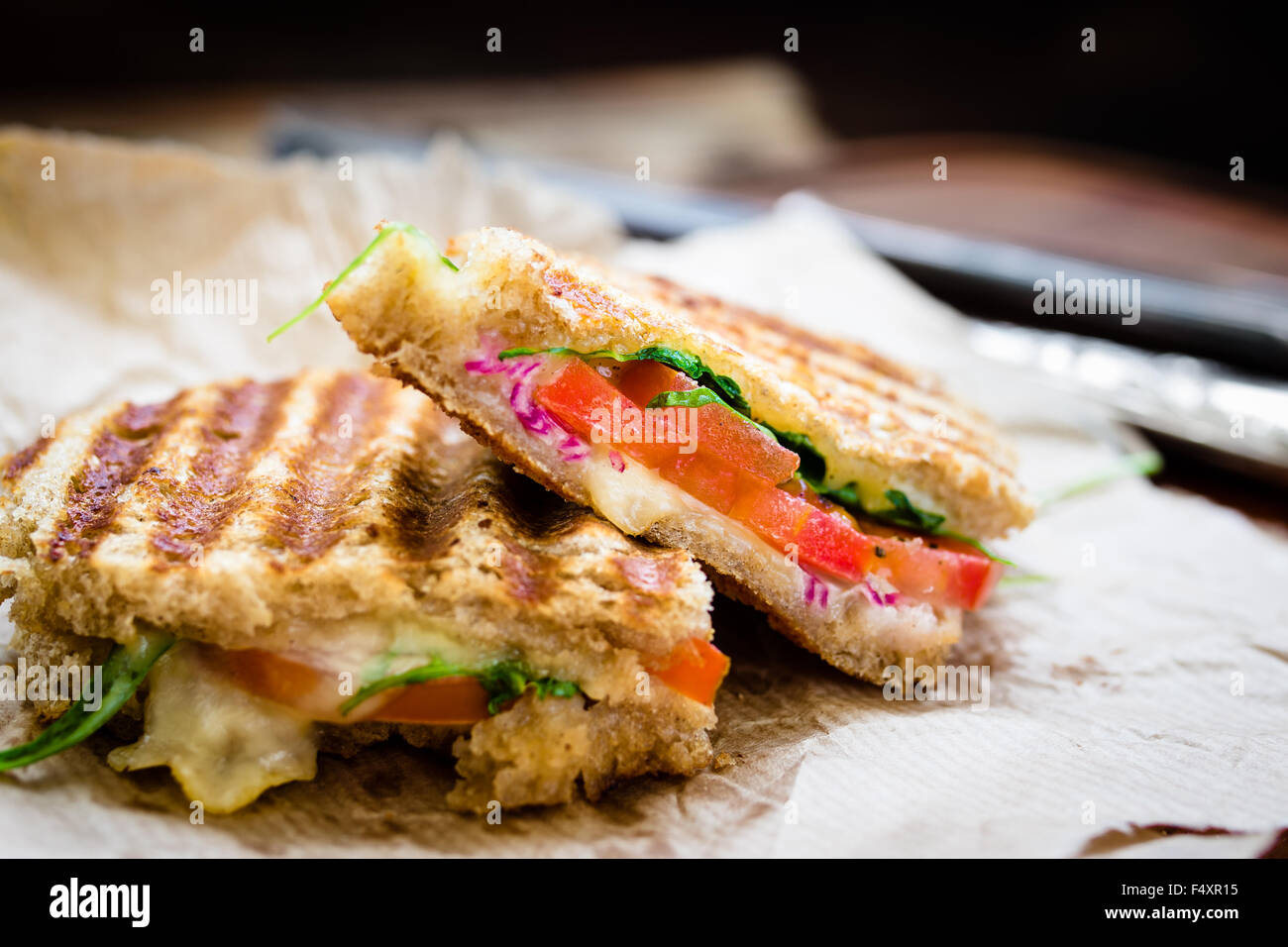 Rustic vegetarian panini with cheese, tomatoes and basil Stock Photo ...