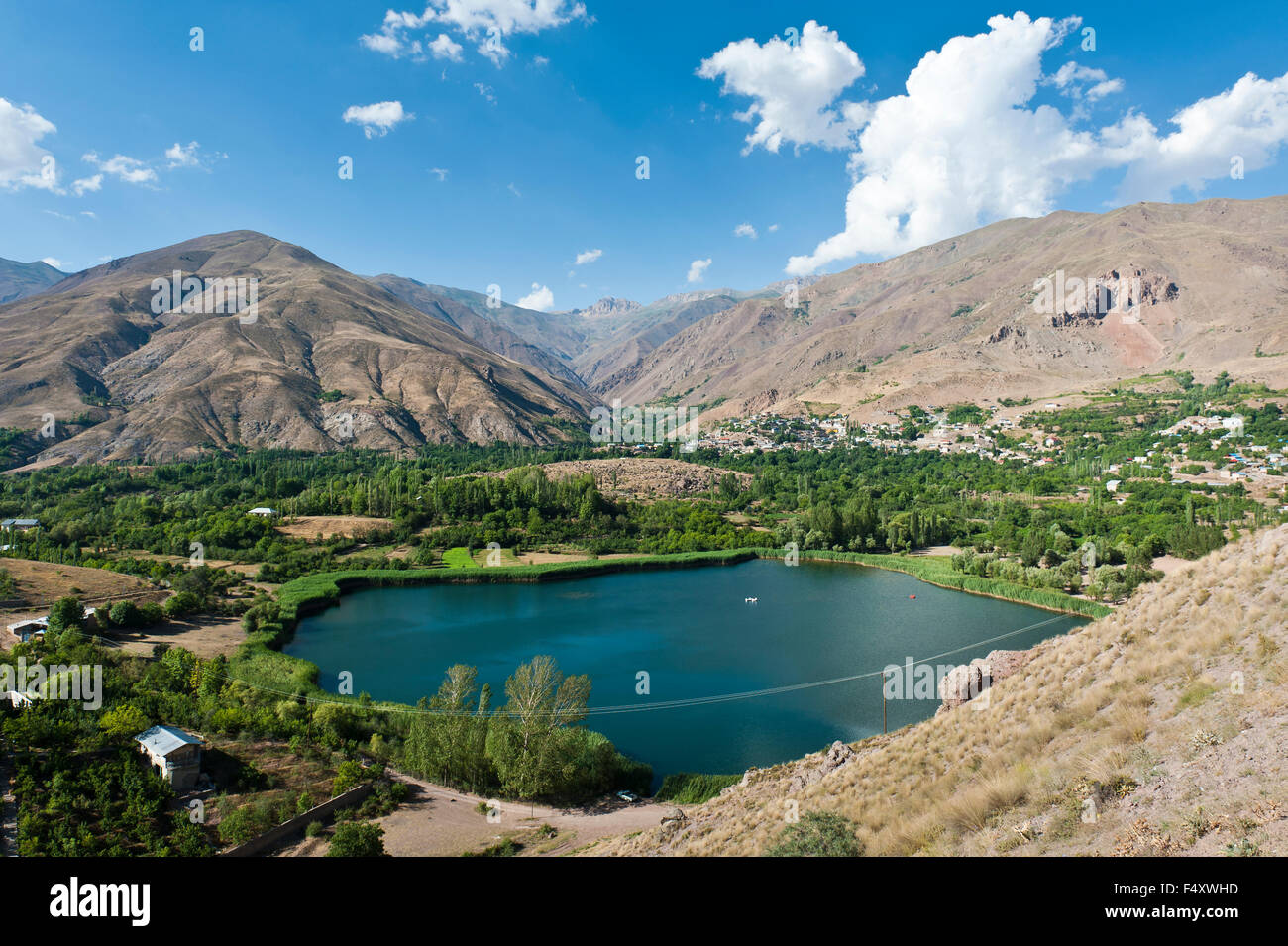 Circular mountain lake, reeds on shore, Ovan Lake, Moallem Kalayeh ...