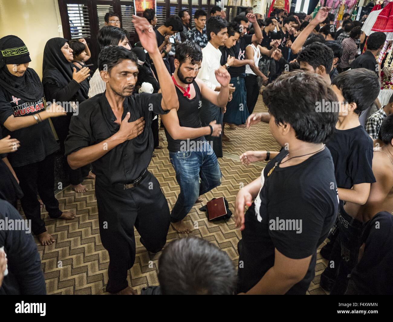 Yangon, Myanmar. 24th Oct, 2015. Shia pray and pound their chests ...