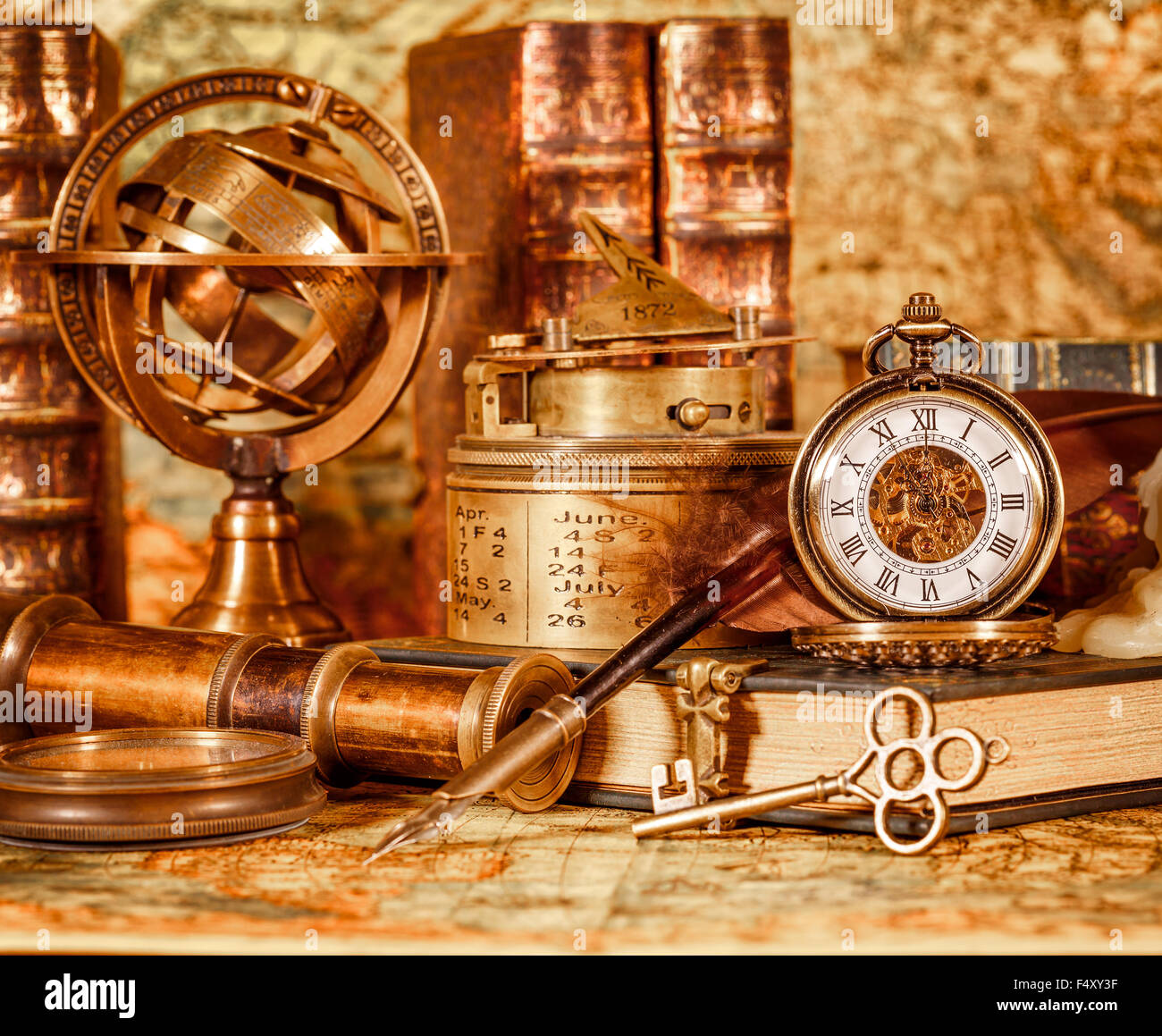 Vintage book, compass, telescope and a pocket watch lying on ancient ...